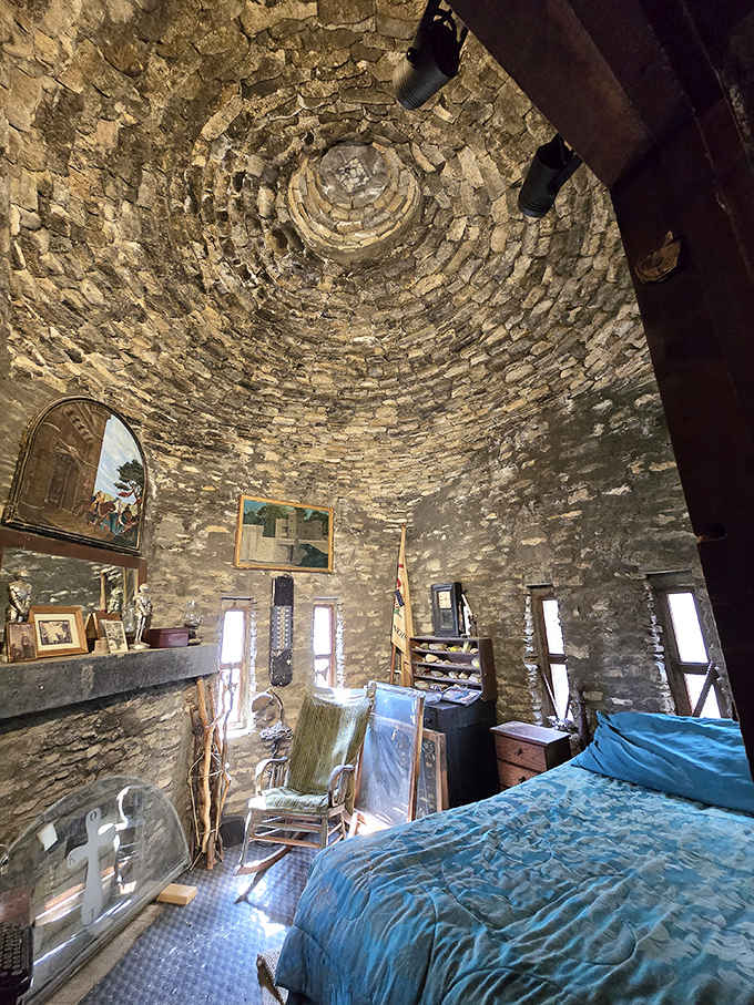 Sleep like royalty in this circular stone bedroom chamber, where every carefully placed rock tells a story of dedication.