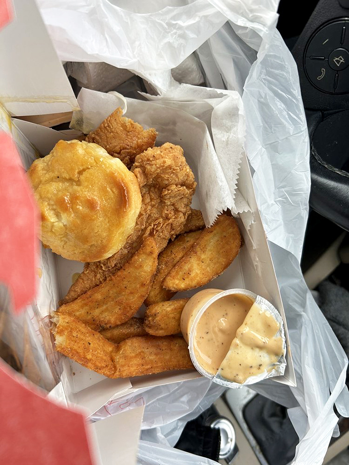 Golden-brown tenders nestled alongside wedge-cut potatoes and a honey-kissed biscuit&mdash;a simple combination elevated to art form through perfect execution.
