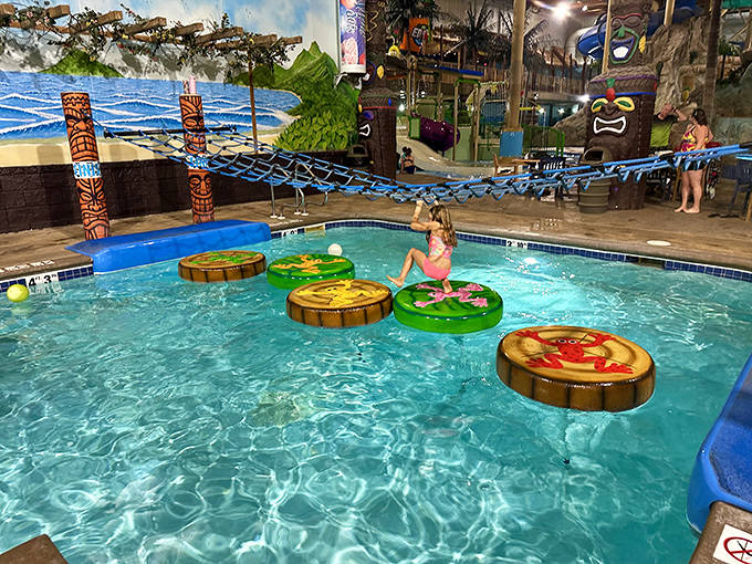 Floating lily pad platforms challenge young adventurers to test their balance while tiki statues stand guard with wooden expressions of mild concern.