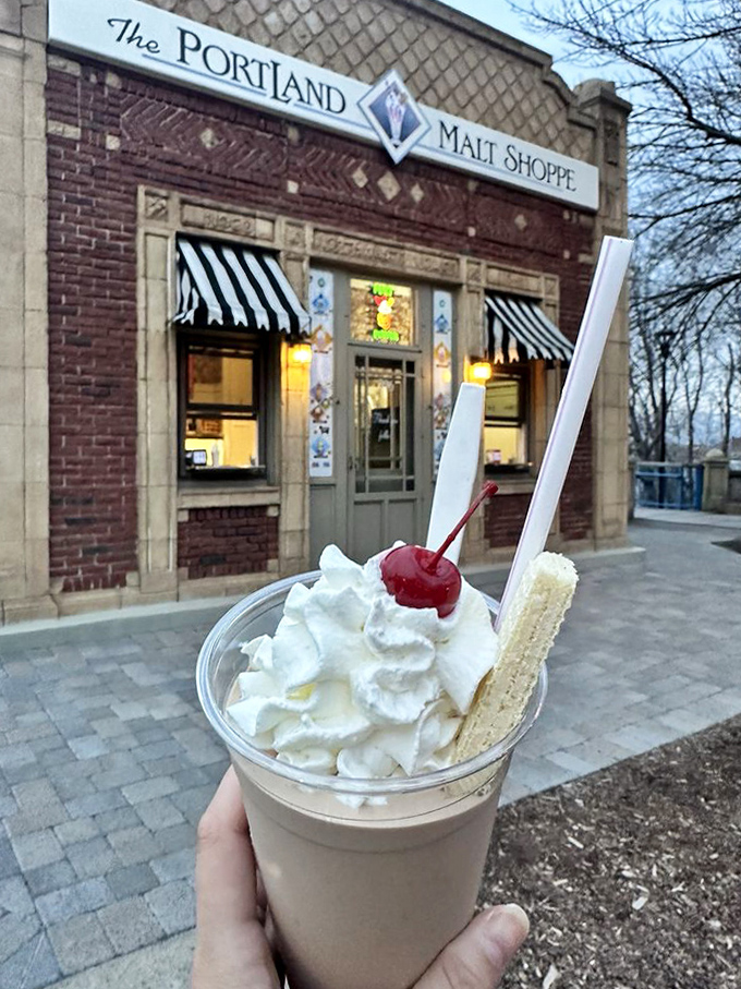 This isn't just dessert, it's architecture&mdash;whipped cream skyscraper, cherry penthouse, and that wafer cookie balcony overlooking a malty masterpiece.