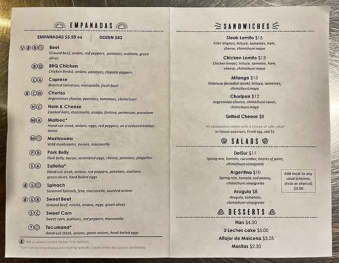 Decision time! The menu board showcases over a dozen empanada varieties, each hand-crafted with authentic Argentine fillings that'll make your taste buds tango.