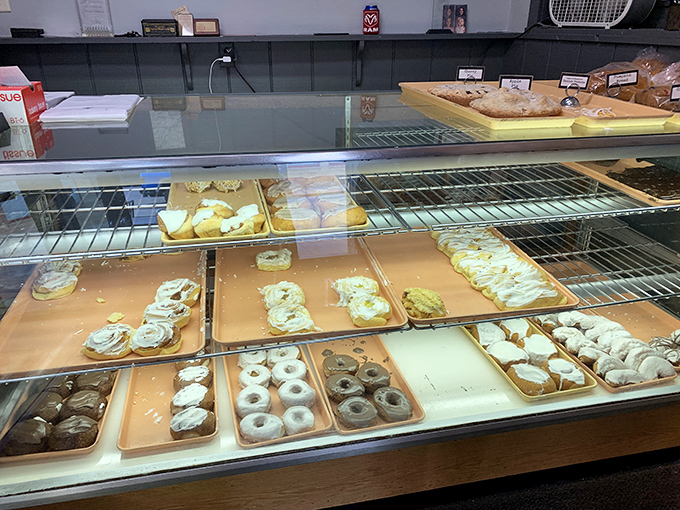 The display case tells sweet stories without words, each tray offering a different chapter in this bakery's century-long tradition.