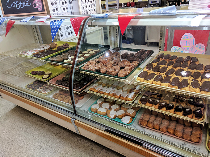 Gazing into this donut case is like peering through a kaleidoscope of possibilities &ndash; each tray a different pathway to happiness.