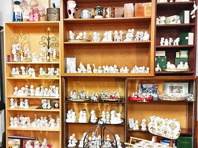 Precious Moments figurines stand in formation, their innocent faces having witnessed decades of changing trends while remaining eternally cute.