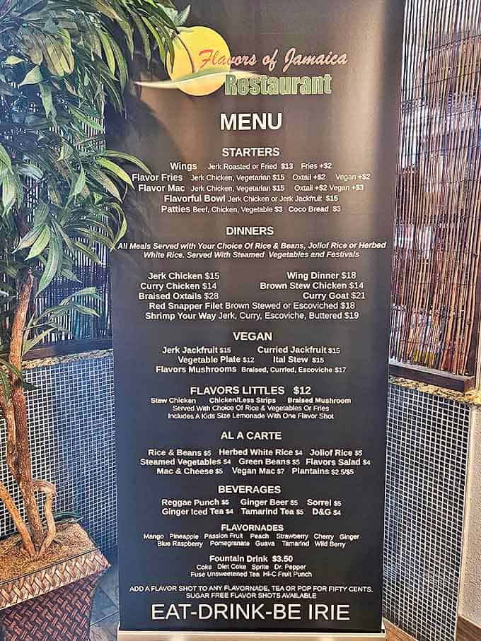 The menu board showcases Jamaica's greatest hits, from jerk chicken to curry goat, with options that'll make both carnivores and vegans swoon.