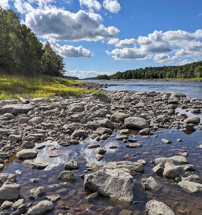 Nature's mosaic: The rocky shoreline of the Rainy River tells geological stories while providing perfect spots for contemplative river-watching.