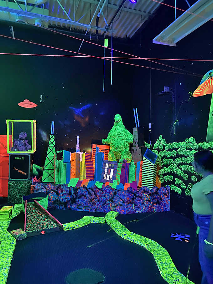 Putting past Godzilla? Just another day at Space Golf, where pop culture monsters loom large over the vibrant, glowing course.