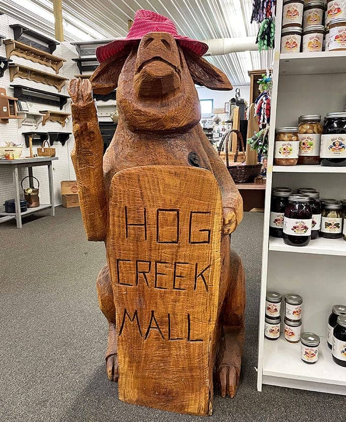 This charming wooden cow wearing a sun hat and holding a "Hog Creek Mall" sign perfectly captures the whimsical spirit that makes browsing here such a delightful adventure.