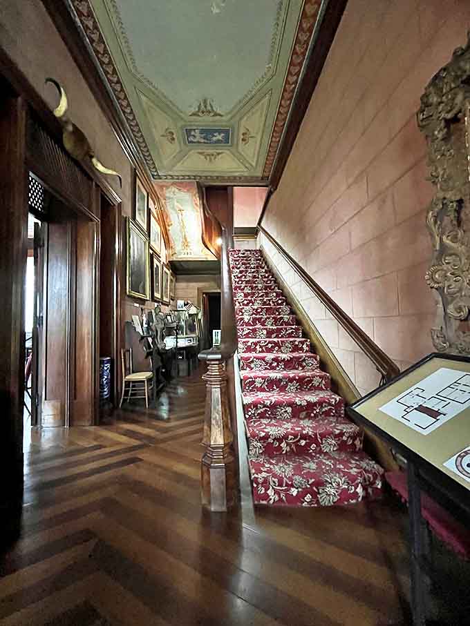 Step inside and travel back in time &ndash; the grand entrance hall welcomes visitors with its herringbone floors and elegant staircase adorned with rich crimson carpeting.