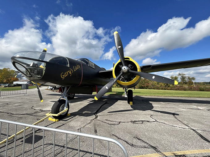 This sleek aircraft sits outside like it's ready to leap into the sky at any moment, its polished surface reflecting clouds that it once soared through during its active service years.