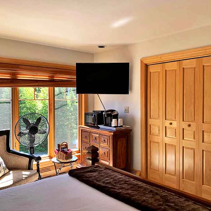 Cozy elegance defines this bedroom sanctuary, where natural wood finishes and plush bedding invite you to linger just five minutes longer.