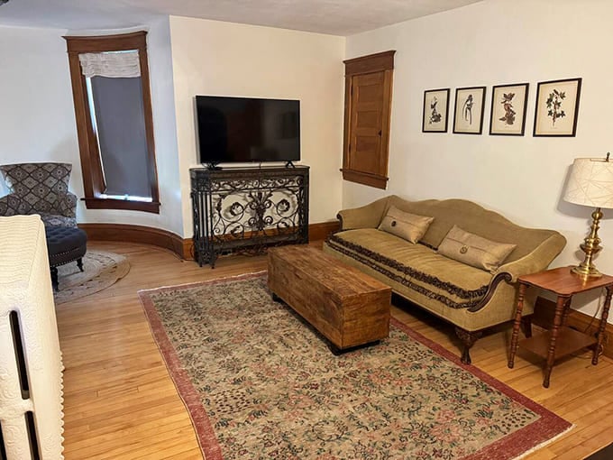 The living room balances historic castle vibes with "thank goodness for Netflix" modern comforts – medieval charm without medieval discomforts.