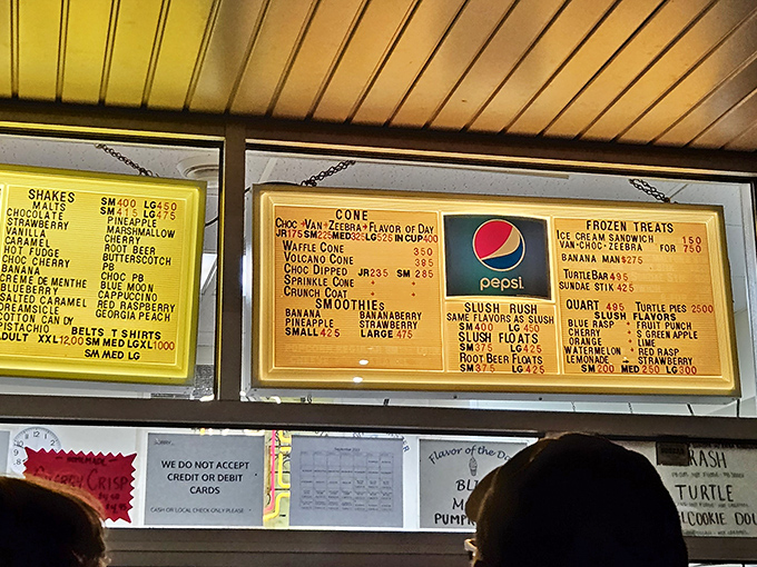 The legendary menu board showcases a dizzying array of flavors and treats, from Blue Moon to Turtle Pies, each promising sweet salvation.
