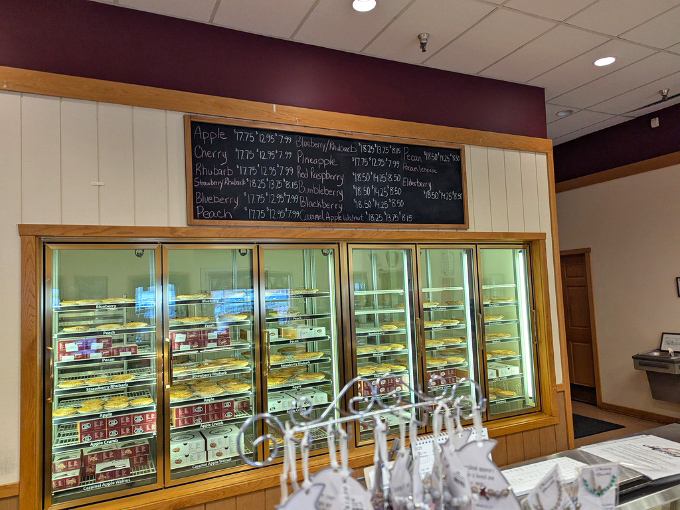 The chalkboard menu reads like poetry to dessert lovers. Each flavor represents not just a pie, but a commitment to the art of proper baking.