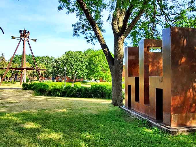 Metal sculptures create striking silhouettes against the Minnesota sky, their geometric forms playing with light and shadow throughout the day.