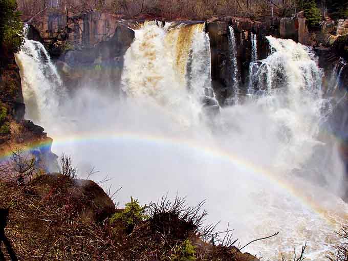 Mother Nature's light show: Sunlight dances through the mist at High Falls, painting ephemeral rainbows that appear and vanish like magic.