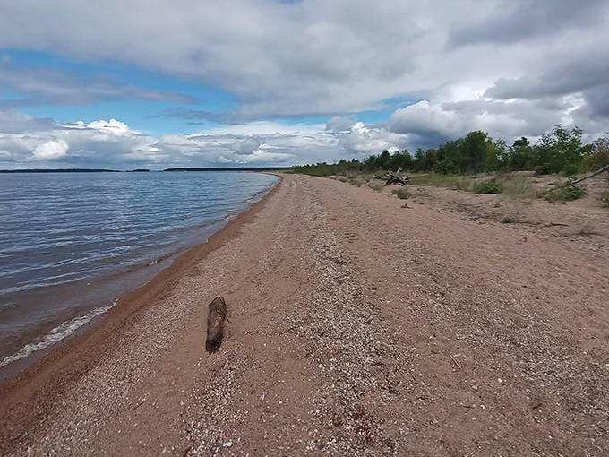 The island's pristine shoreline stretches invitingly, where each footprint tells a story of discovery and temporary escape.