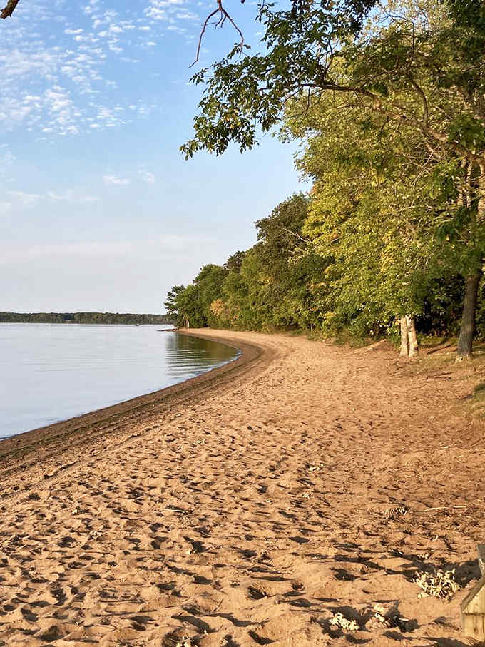 The sandy shoreline curves gently along Mille Lacs Lake, offering enough space for everyone to claim their own slice of beach paradise.