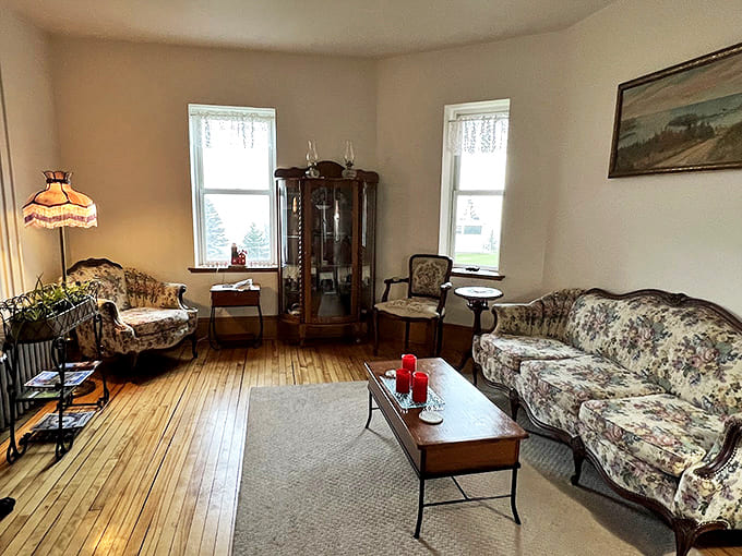 Step back in time in the sitting room, where vintage furnishings and natural light create the perfect spot for morning coffee or evening conversation.
