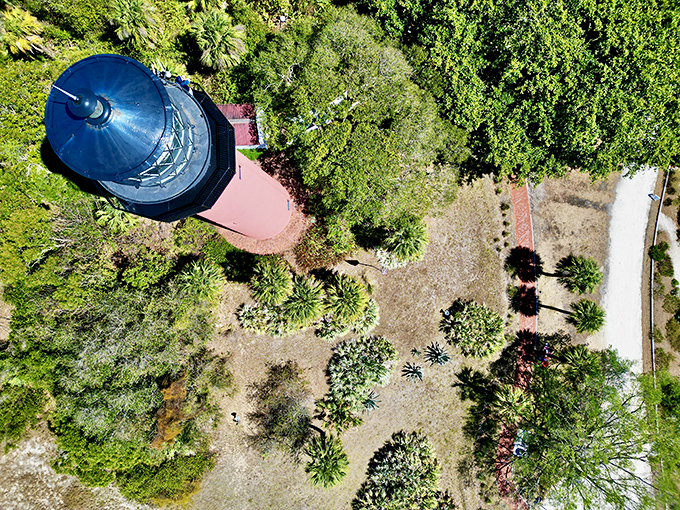 A bird's-eye view reveals the lighthouse's strategic position, commanding the waterway like a chess master controls the board.