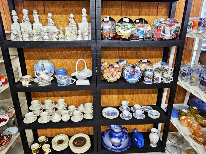 Delicate figurines share shelf space with blue and white plates, creating a porcelain neighborhood where your grandmother's cherished collectibles would feel right at home.