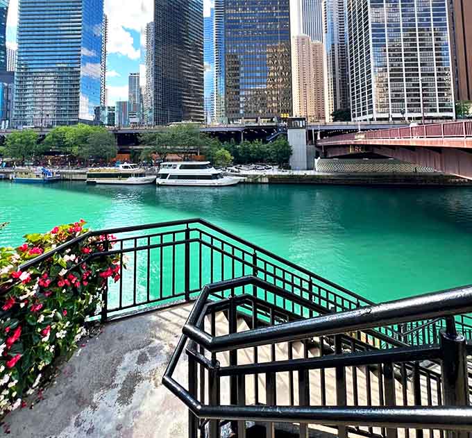 Cascading stairs invite visitors down to the water's edge, where the emerald Chicago River reflects the city's architectural masterpieces in rippling glory.