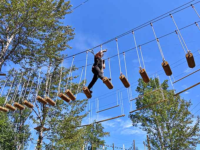 Navigating the suspended wooden logs requires focus and balance &ndash; like walking a tightrope with better views.