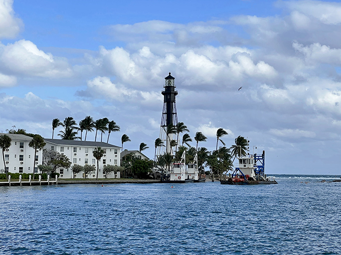The lighthouse stands tall against cloudy skies, a steadfast guardian that's seen more Florida weather drama than a reality TV show marathon.