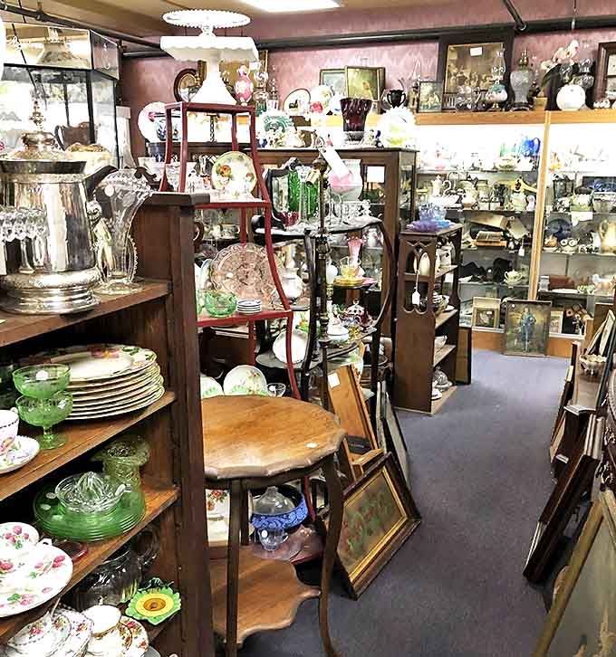 Delicate porcelain and Depression glass await new homes, their shelves resembling a museum display where everything happens to be for sale.