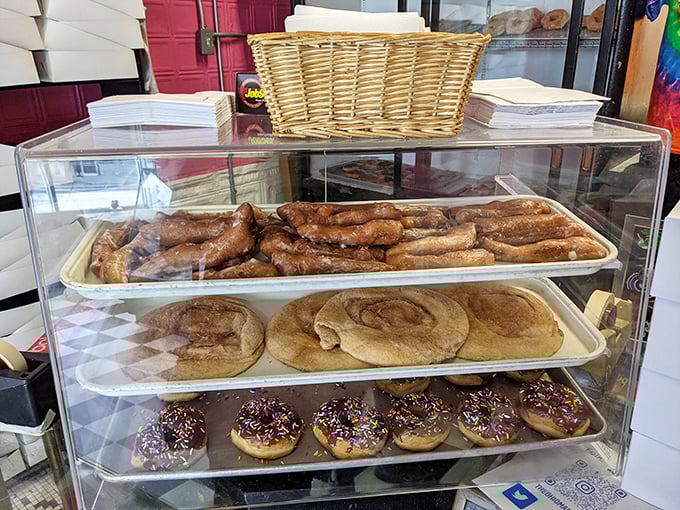 The display case &ndash; where dreams come true and diets go to die. Each tray holds a different path to sugary bliss.