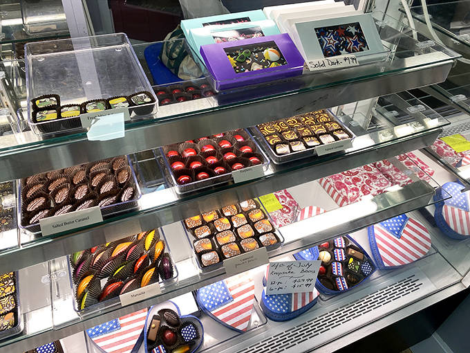 Chocolate heaven awaits in these gleaming display cases, where each handcrafted piece tempts with artistic flair and decadent promise.