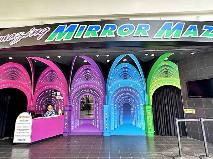 The colorful reception area serves as the gateway between ordinary mall life and the extraordinary world of endless reflections.
