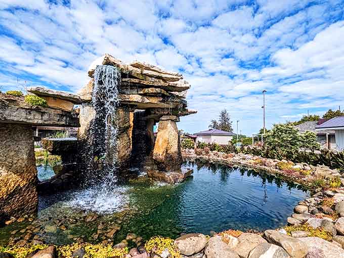Nature and craftsmanship merge at this tranquil waterfall, where visitors pause to reflect amid their wildlife adventures.