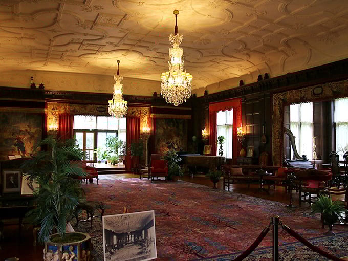 Crystal chandeliers illuminate intricate ceiling details and plush furnishings, creating an atmosphere where even whispering feels too casual.