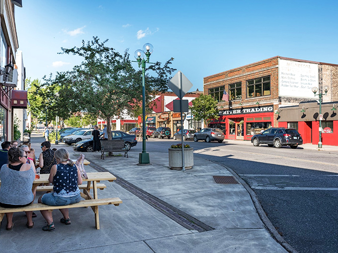 Main Street's vibrant storefronts invite exploration, where locals gather at sidewalk tables to watch the world stroll by.