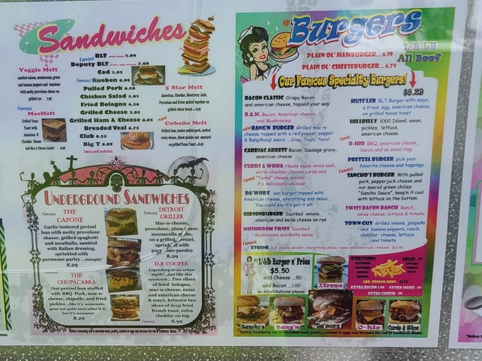 The menu board showcases an impressive array of sandwiches and burgers with playful names that hint at the flavor adventures awaiting.