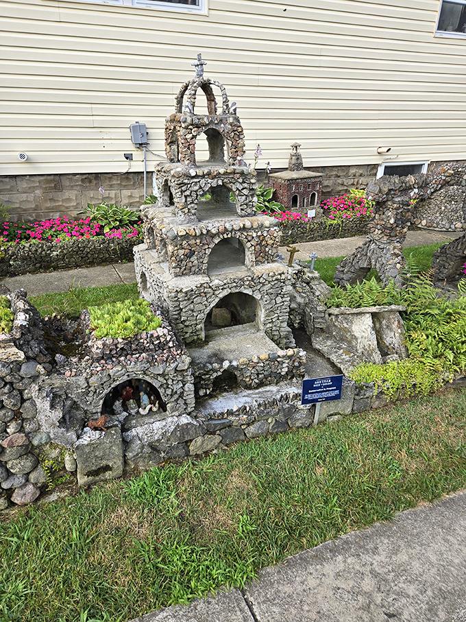This multi-tiered stone structure showcases the meticulous craftsmanship that defines the garden, with each tiny stone placed just so.