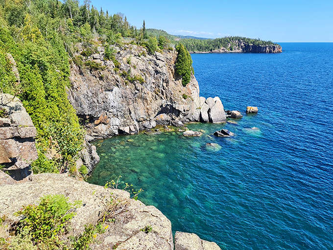 Lake Superior's crystal waters crash against ancient volcanic cliffs, creating nature's version of a spa soundtrack minus the pan flute.