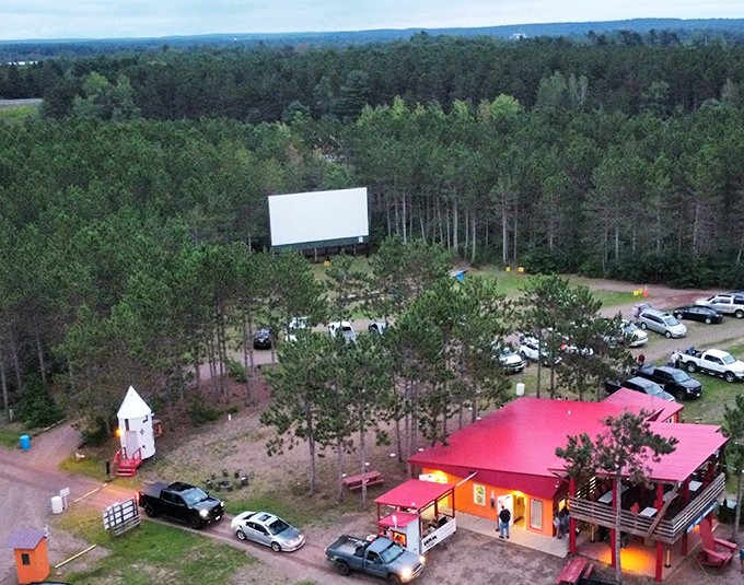 A bird's-eye view reveals the Stardust's perfect forest setting, with the bright red concession building welcoming visitors.