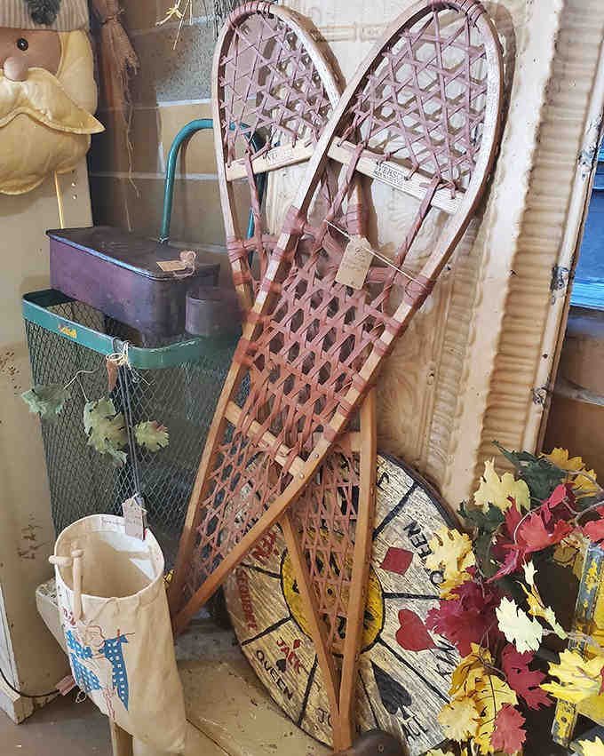 These vintage wooden snowshoes hang patiently, whispering tales of winter adventures across Minnesota's snowy landscapes from decades past.