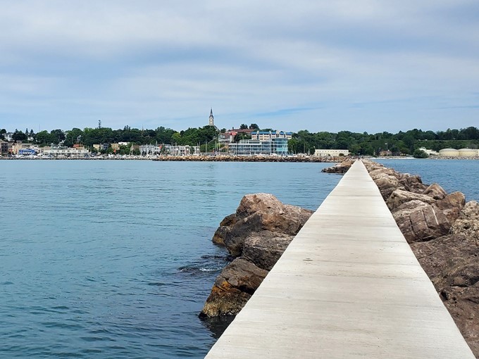 A peaceful stroll along the breakwater path rewards visitors with panoramic views of Lake Michigan's endless blue horizon.