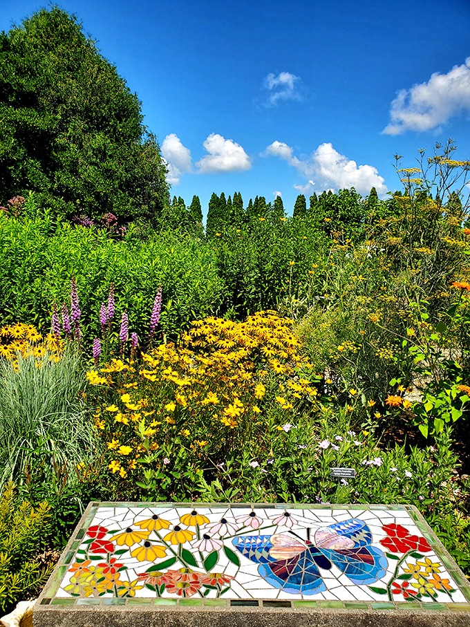 This butterfly mosaic stepping stone offers a permanent pollinator amid seasonal blooms &ndash; art that stays colorful even when Wisconsin winter arrives.