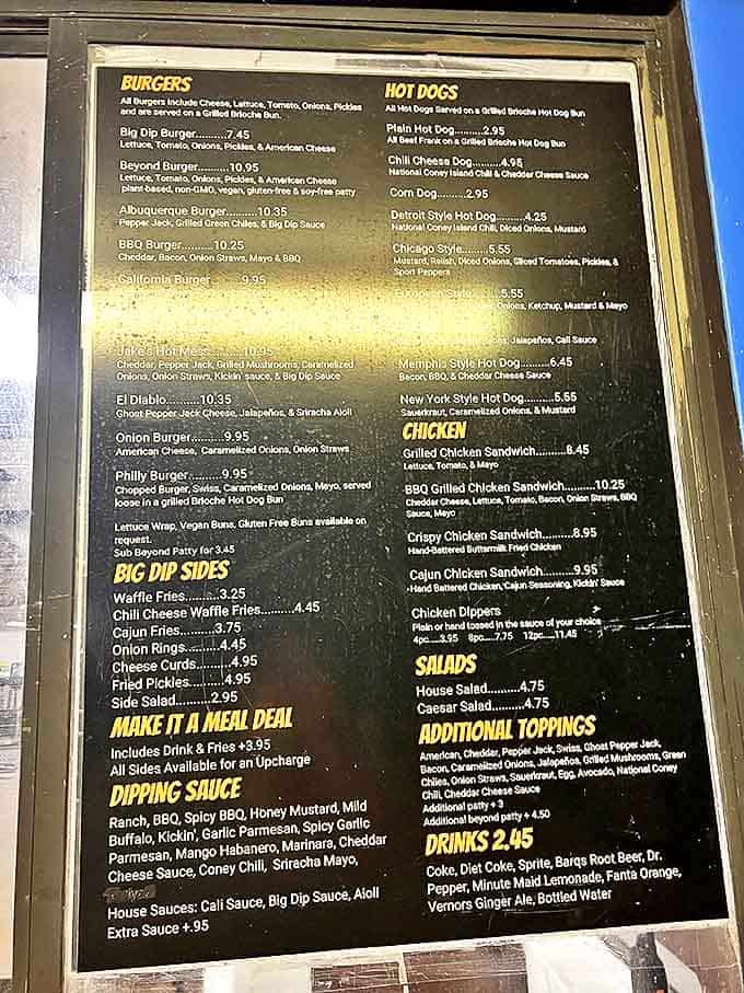 The menu board tells a story of burger possibilities, each option more mouth-watering than the last. Choose wisely, friends.