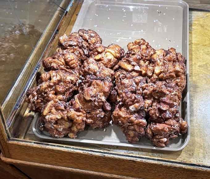 These aren't just apple fritters &ndash; they're irregular masterpieces of fried dough, apple chunks, and glaze that would make Michelangelo weep with joy.