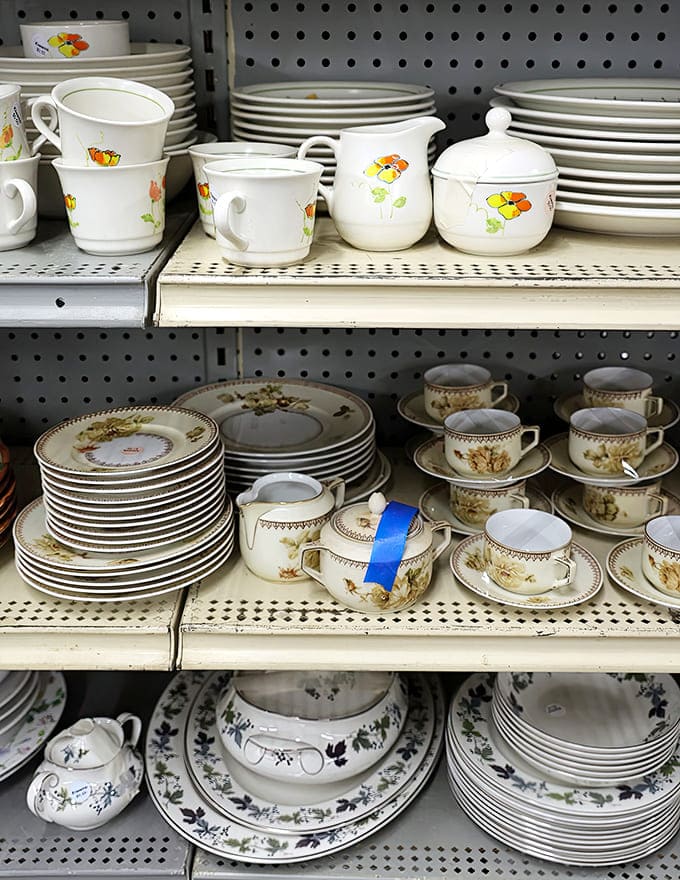 Dishware: Grandma's china meets retro diner plates. These shelves hold the secret ingredients to unforgettable dinner parties and nostalgic Sunday brunches.