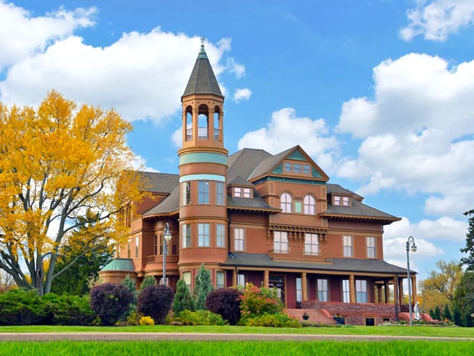 Fairlawn Mansion's distinctive reddish-brown exterior and impressive tower stand as a testament to Victorian elegance in Superior, Wisconsin.