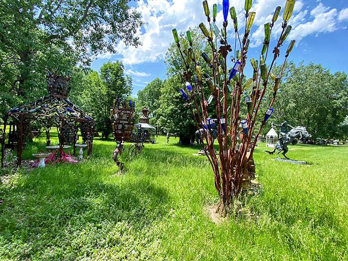 A bottle tree sparkles in the sunlight at M Schettl Sales, where everyday objects transform into magical art installations across the sprawling grounds.