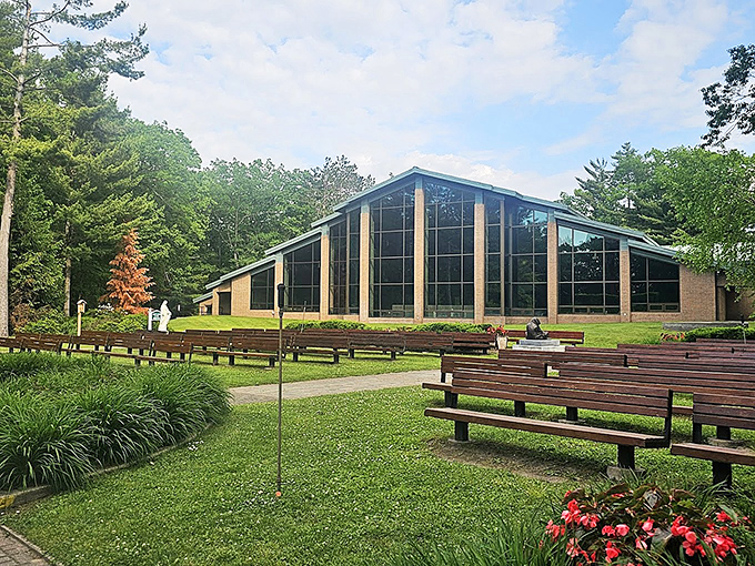 The modern glass-fronted sanctuary at the Shrine of the Cross creates a peaceful setting for spiritual reflection and nun doll viewing.