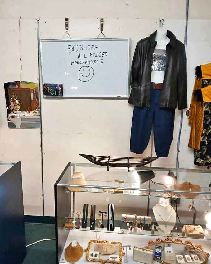 Bargain hunters rejoice! The cheerful whiteboard announces 50% off all merchandise, turning already good deals into irresistible steals that'll have you reaching for your wallet.