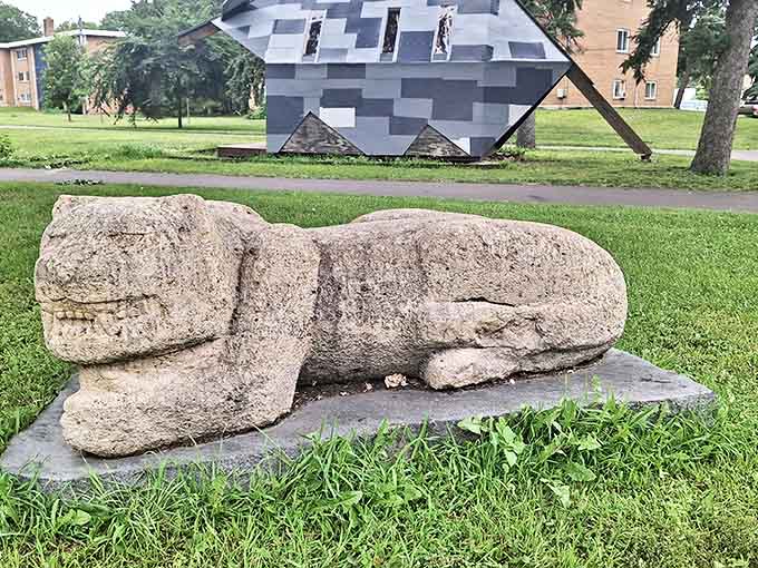 This weathered stone creature patiently waits for visitors, looking like it might have wandered straight out of a prehistoric Minnesota.